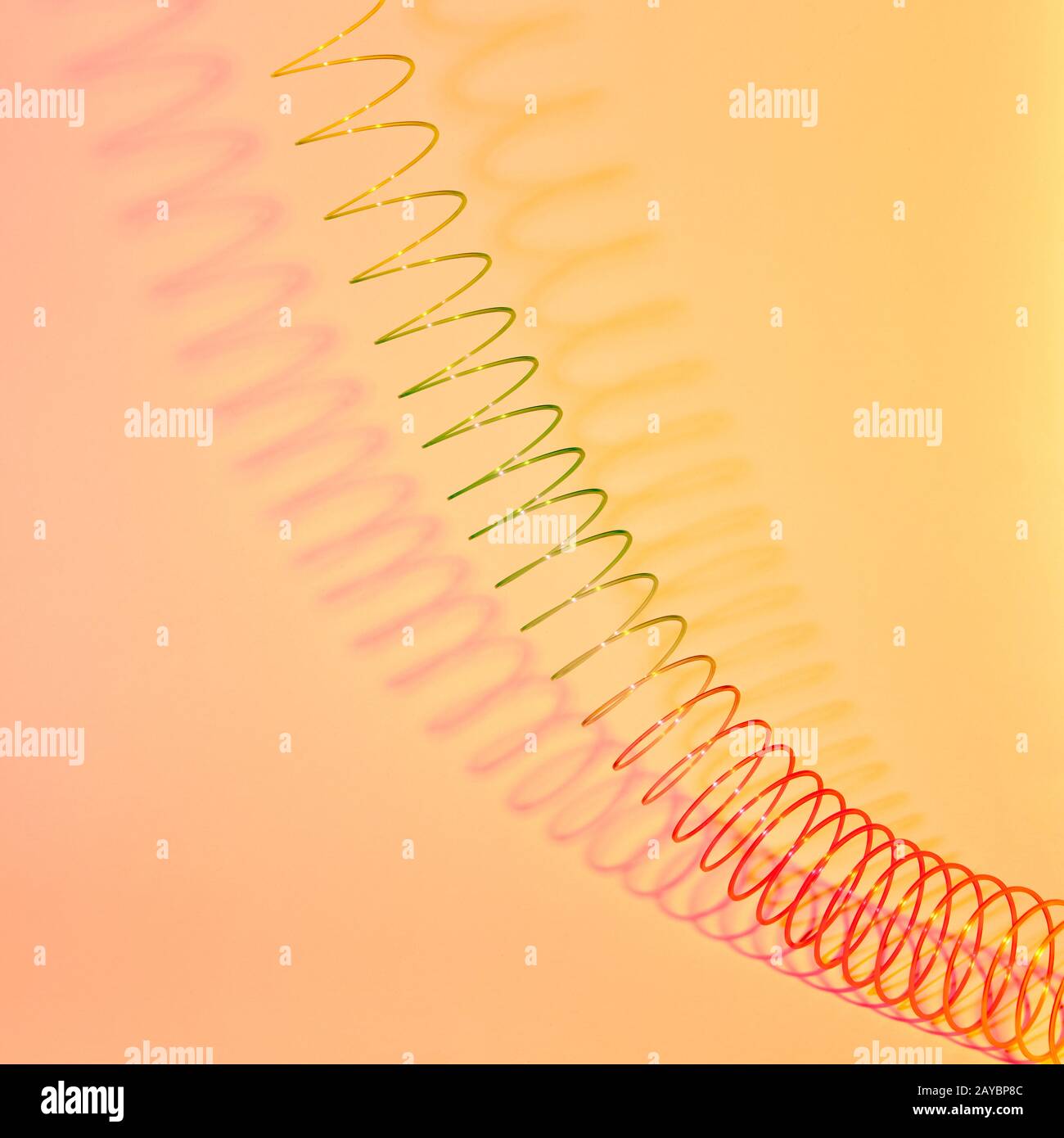 Stretching rainbow plastic spring toy with shadows Stock Photo - Alamy