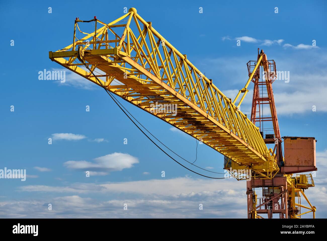 Jib crane tower against blue sky Stock Photo - Alamy