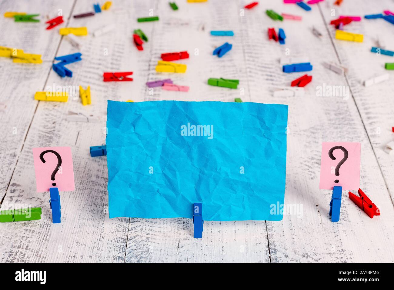 Scribbled and crumbling papers with paper clips placed on the wooden ...