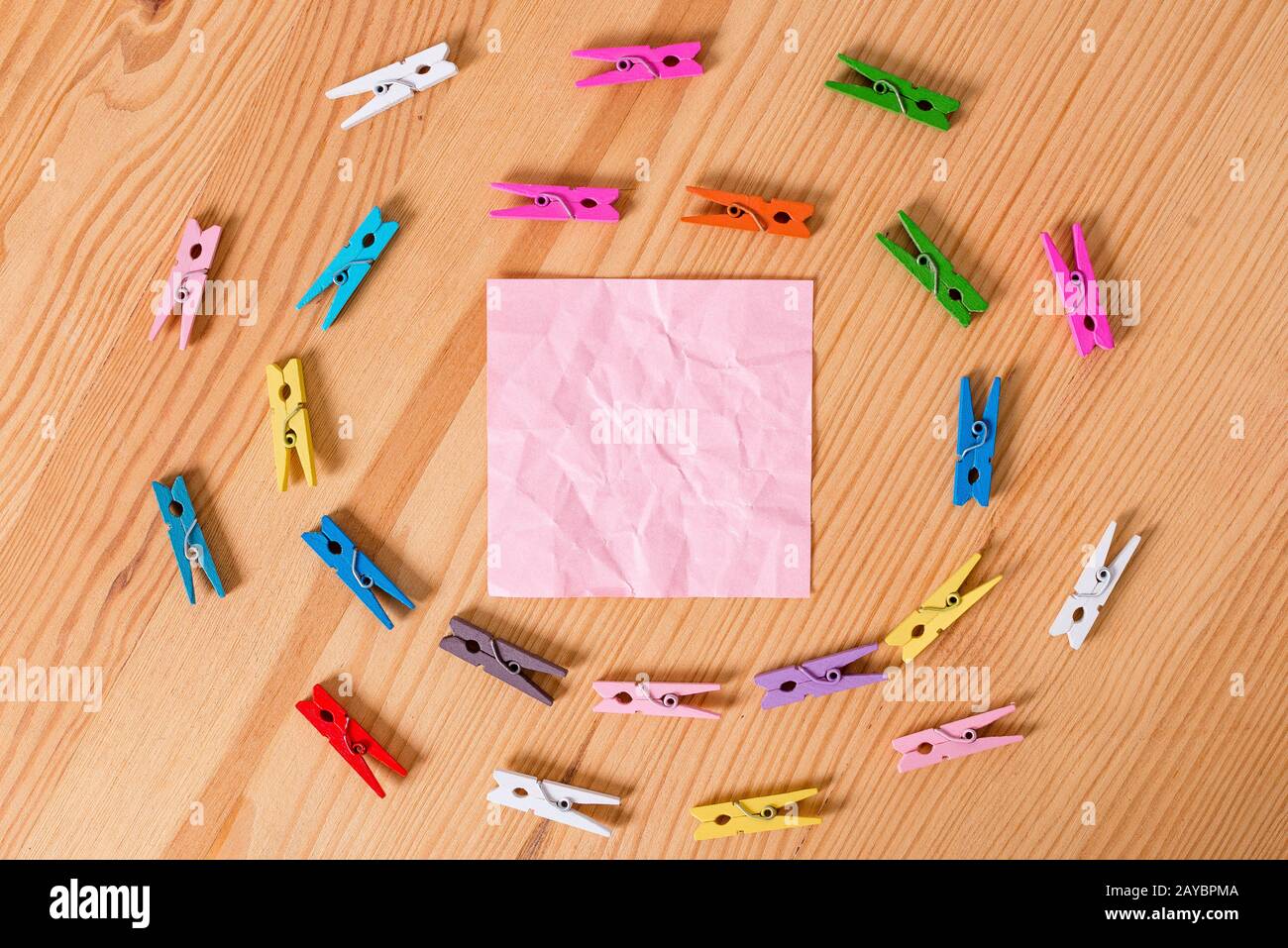 Colored clothespin spread in circles around an empty rectangle square ...