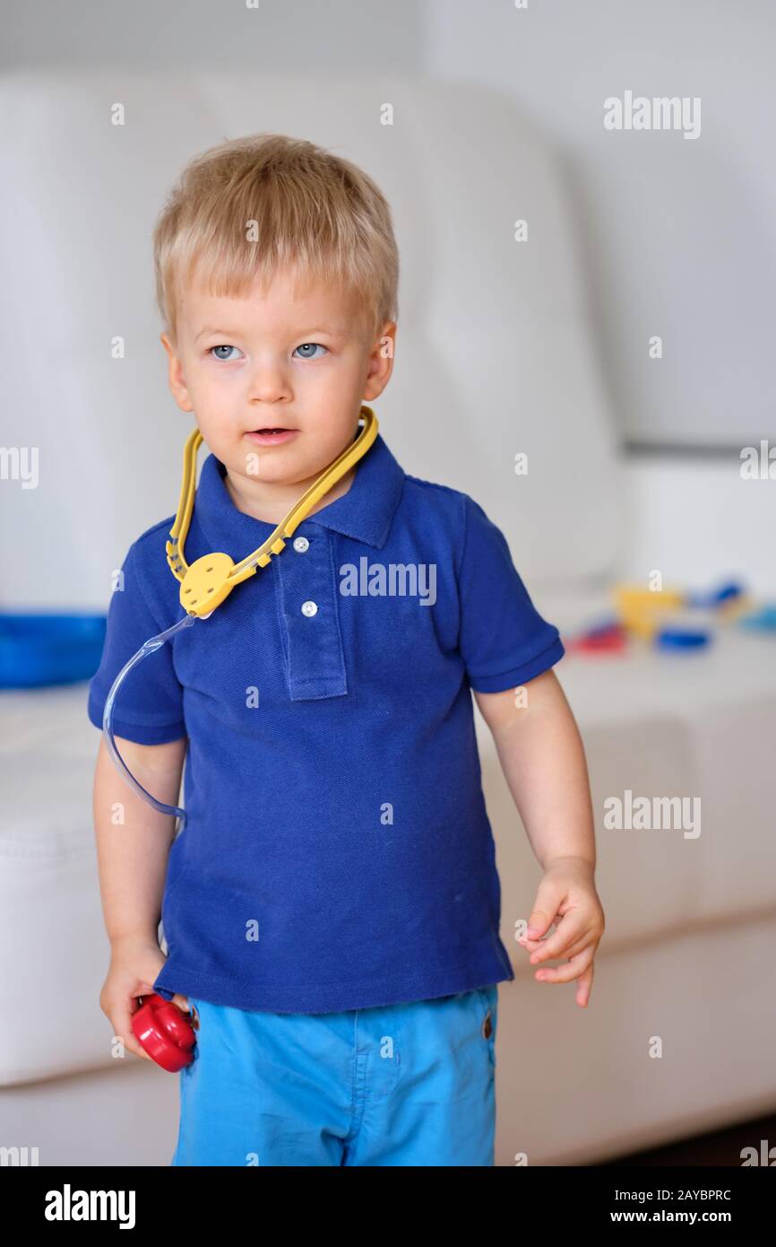 Two year old boy playing doctor Stock Photo - Alamy