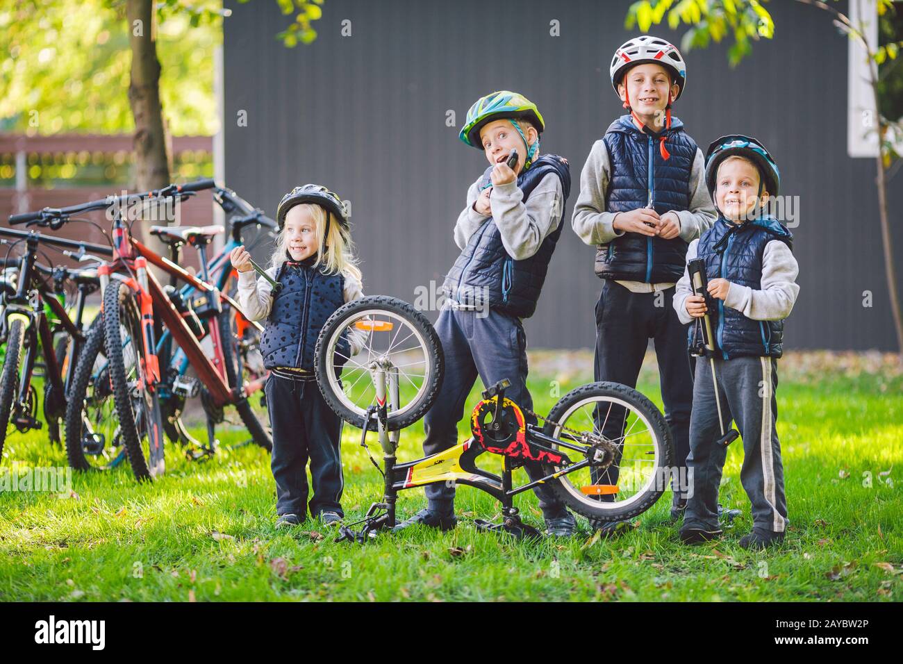 Children mechanics, bicycle repair. Happy kids fixing bike together ...