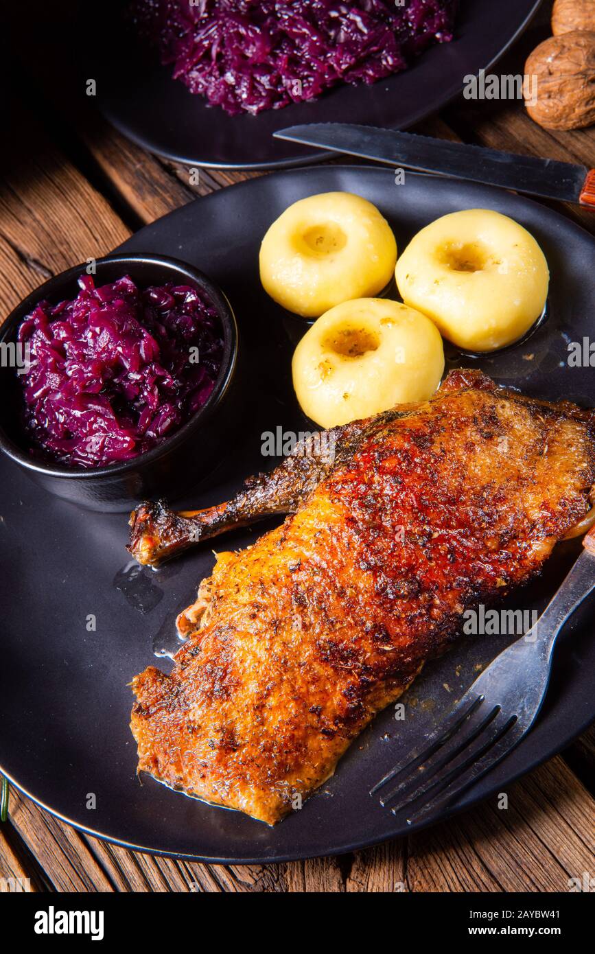 Roast goose with baked apples, red cabbage and dumplings Stock Photo ...