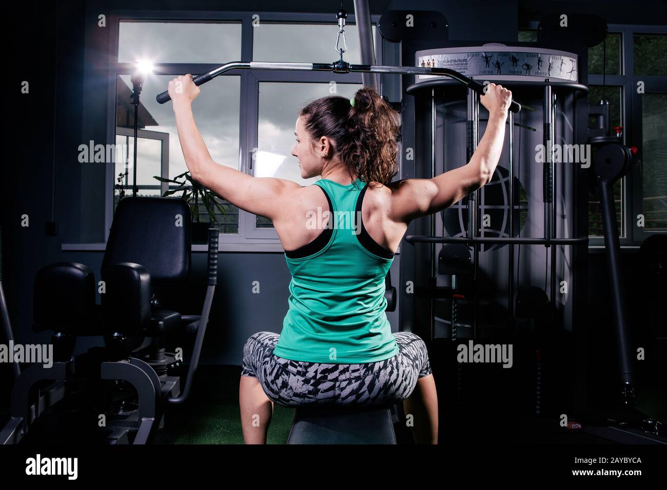 A back view of a trained girl doing exercises. Training for back ...