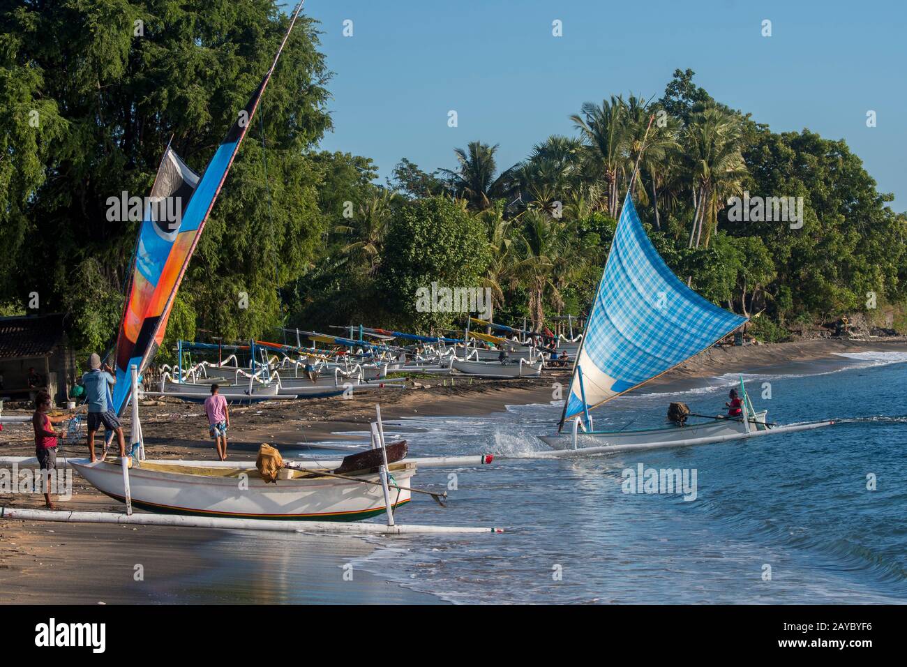 Traditional Balinese fishing boats (Junkung) landing on a beach in Amed ...