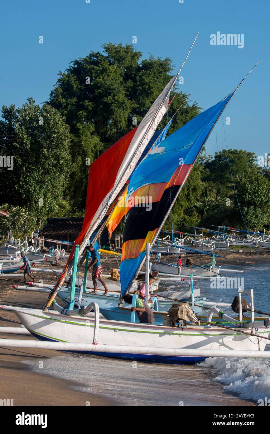 Traditional Balinese fishing boats (Junkung) landing on a beach in Amed ...