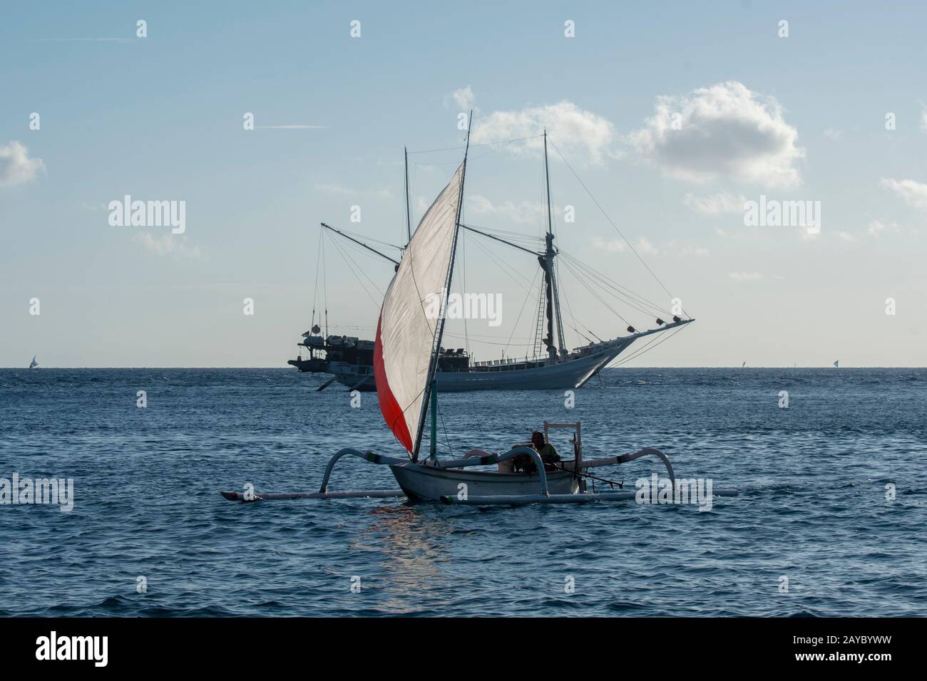 A traditional Balinese fishing boat (Junkung) with the MSV Katharina, a ...