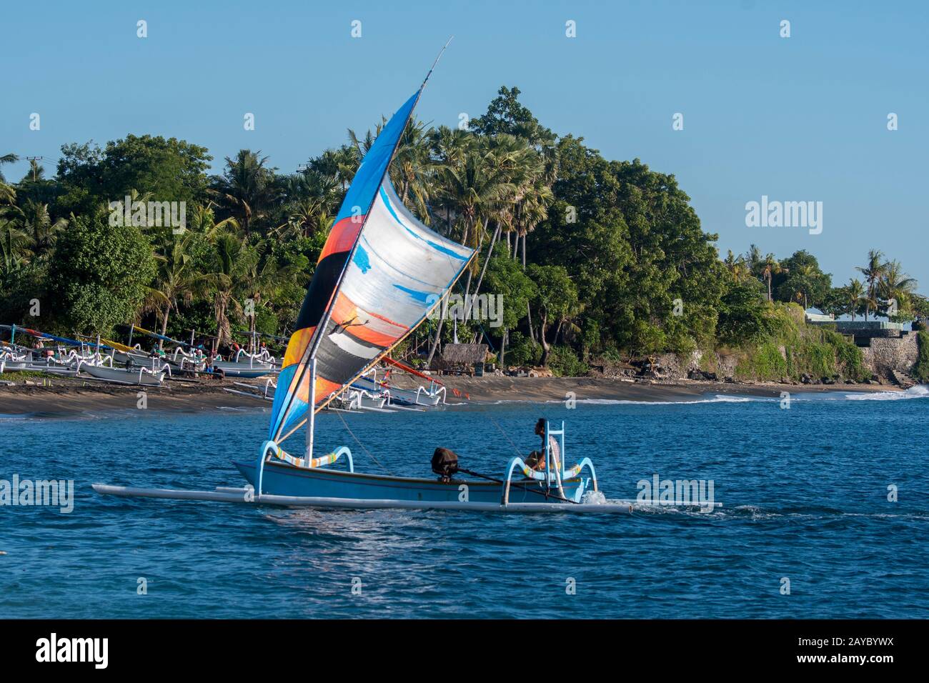 A traditional Balinese fishing boat (Junkung) at sea in front of Amed ...
