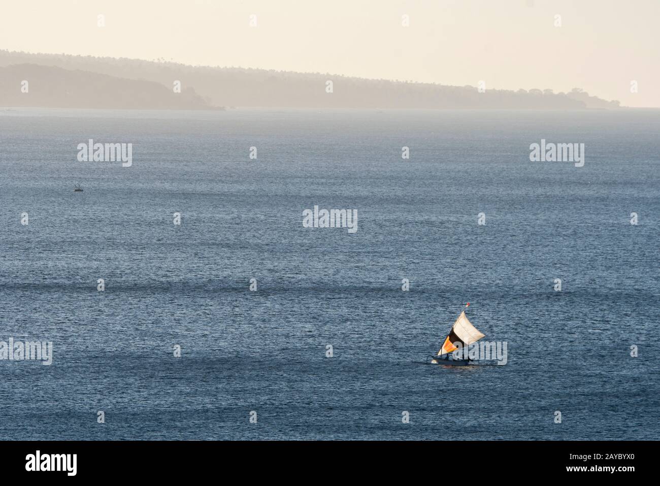 A traditional Balinese fishing boat (Junkung) at sea in front of Amed ...