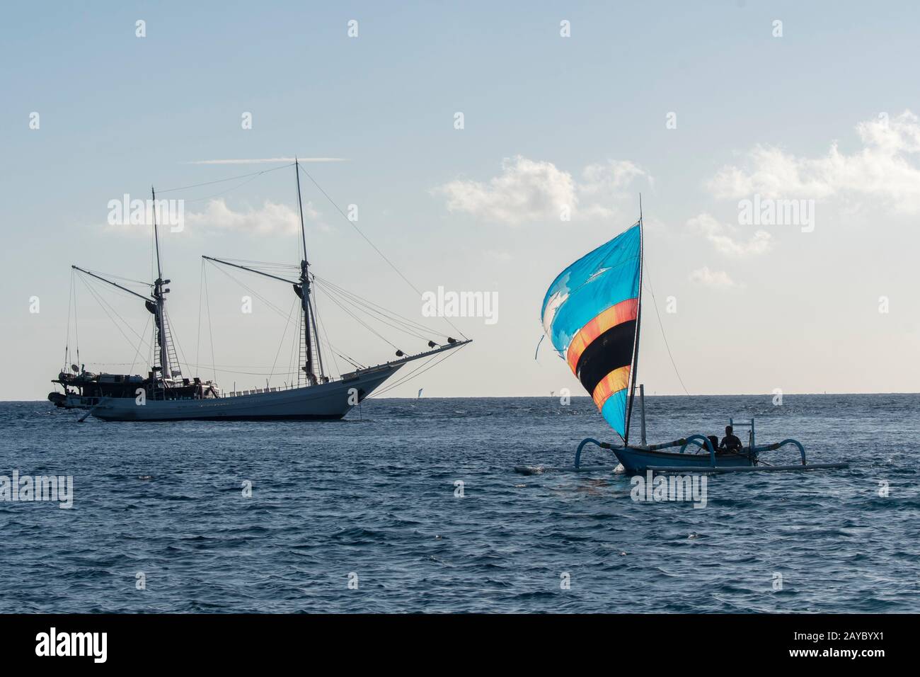 A traditional Balinese fishing boat (Junkung) with the MSV Katharina, a ...