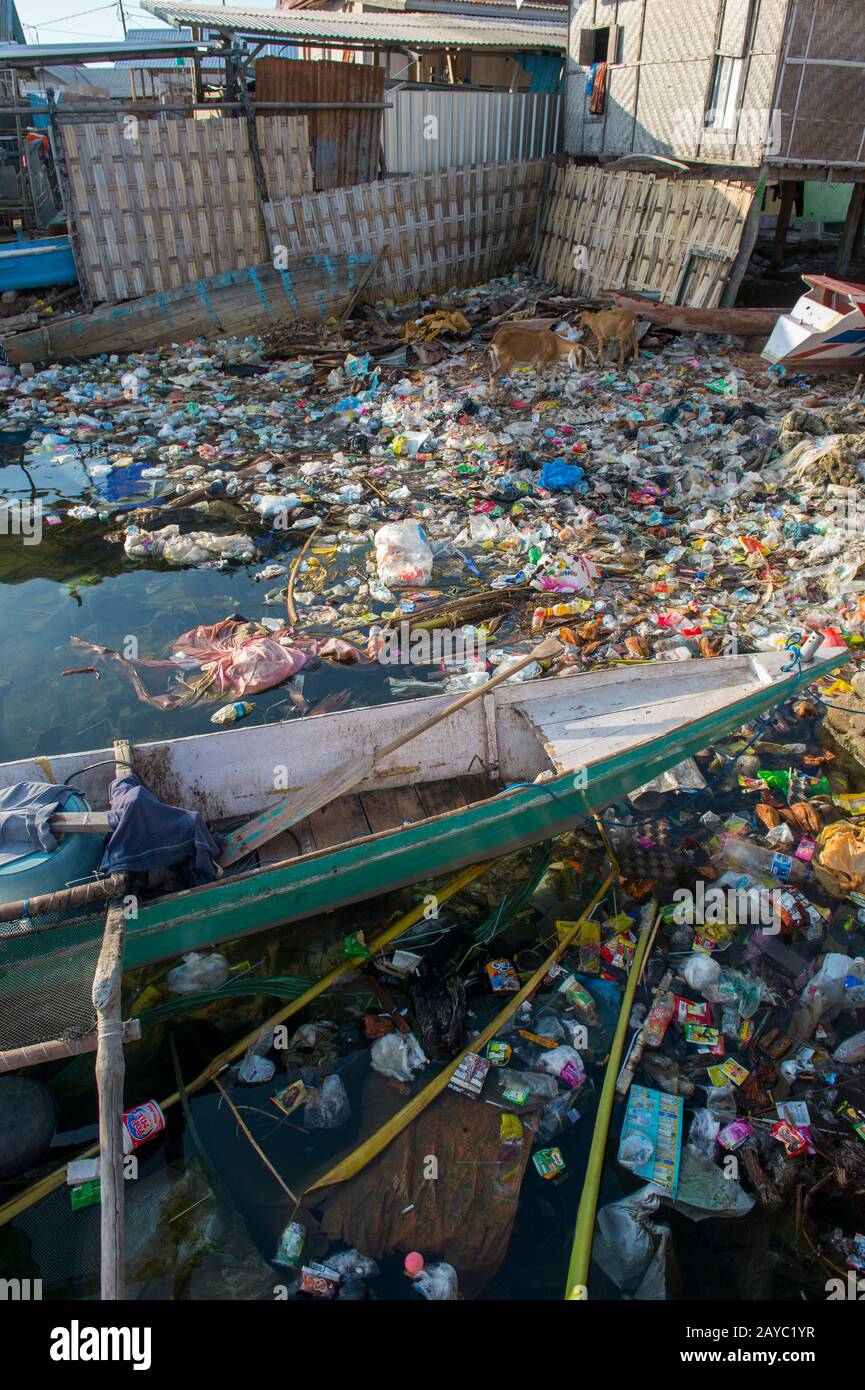Garbage, mostly plastic, floating on the water at the Bajau Sea Gypsy ...