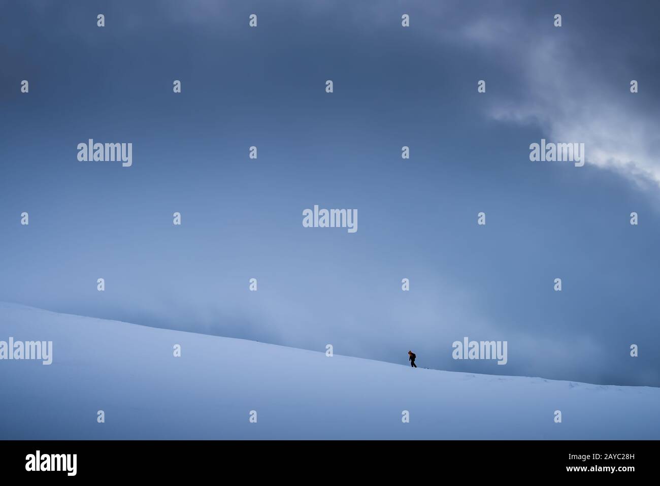 Trekker walking towards Storsteinen mountain summit Stock Photo - Alamy