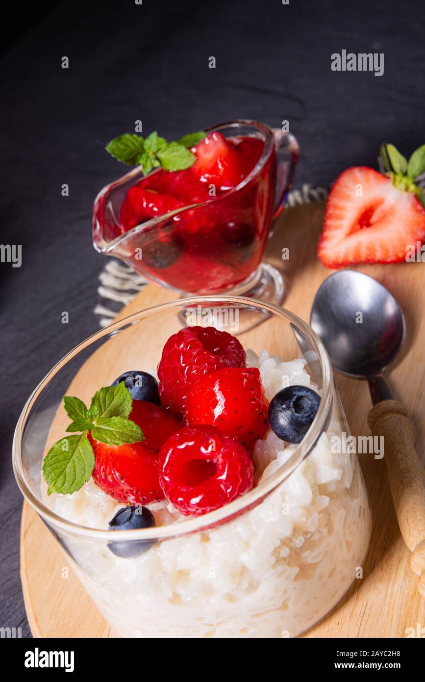 delicious milk rice with different berries and red fruit jelly Stock ...