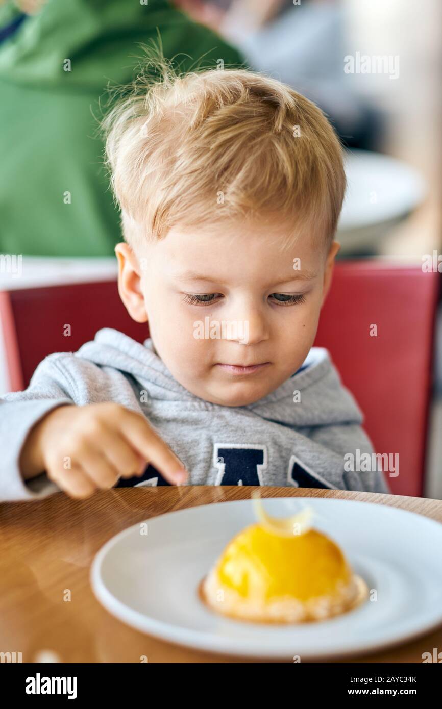 Boy eating dessert in cafe Stock Photo - Alamy