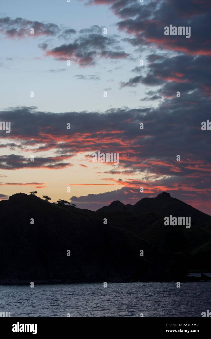 View of the sunset from a bay on Padar Island located between Komodo ...