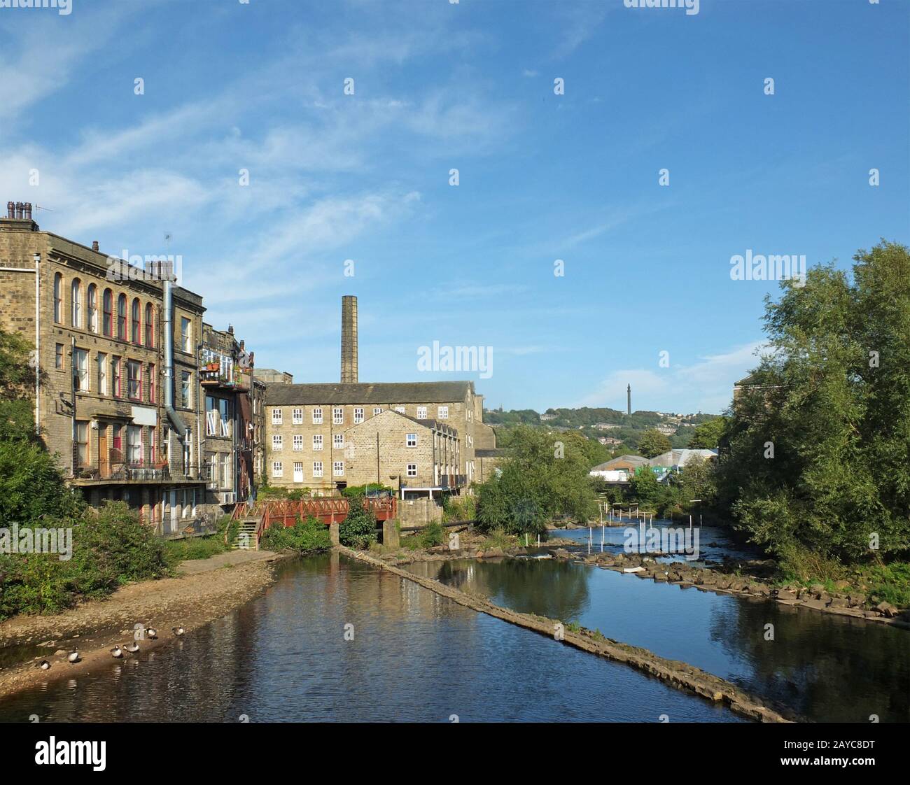 the river calder in sowerby bridge with buildings reflected in the ...