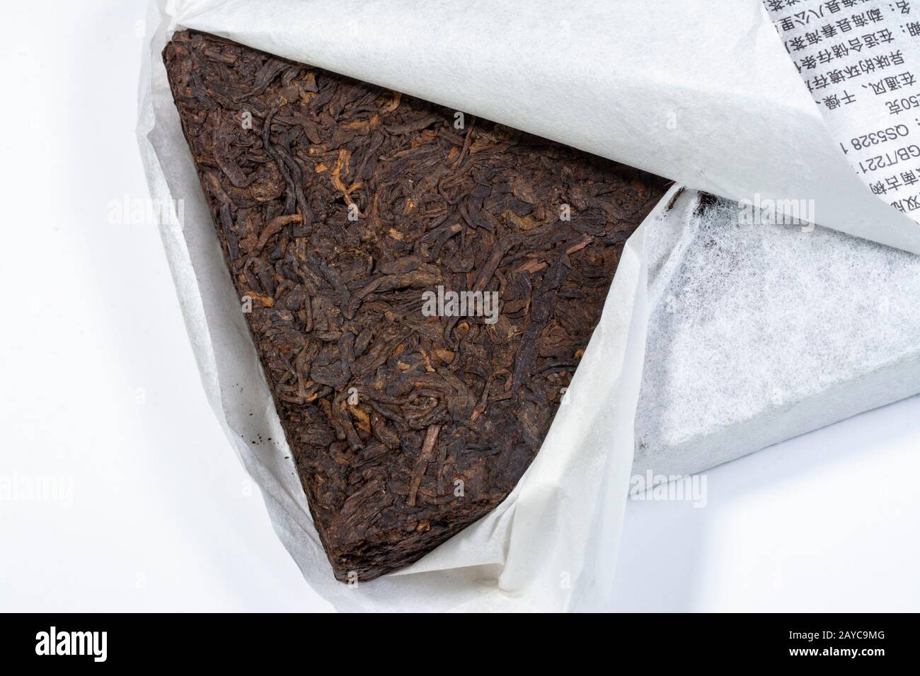 Chinese Yunnan Pu Erh tea block wrapped in white silk paper Stock Photo ...