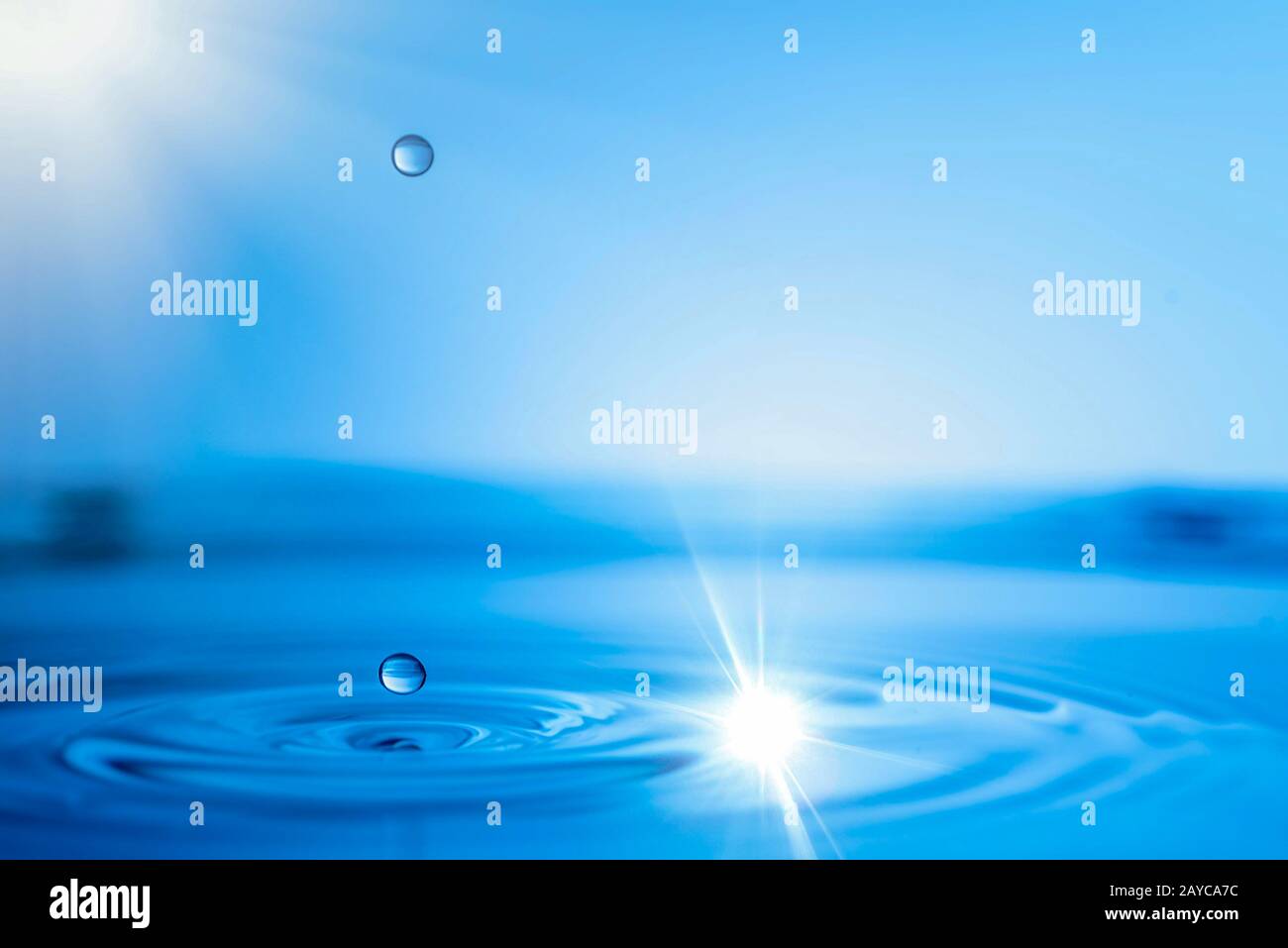 Water drop splash on water surface Stock Photo - Alamy