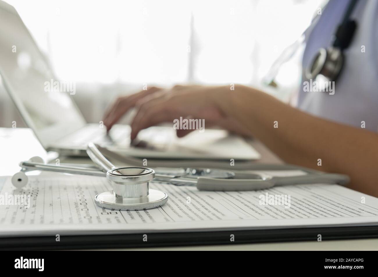 Close-up of a doctor typing on keybord in the office Stock Photo - Alamy