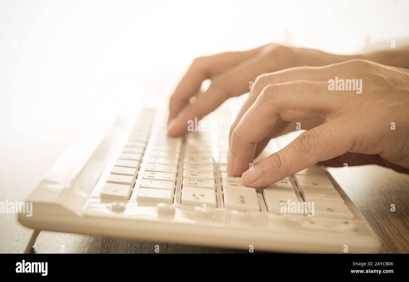 human's hands typing on computer keyboard. selective focus Stock Photo ...