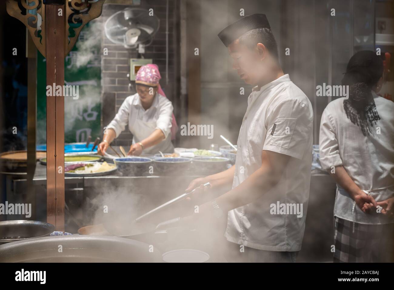 Chinese chef preparing hot food Stock Photo - Alamy