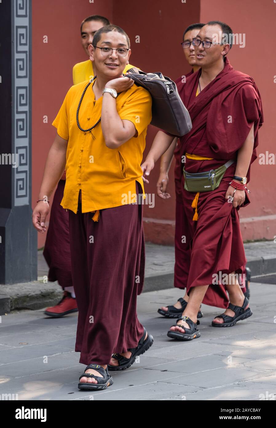 Buddhist monk wearing red robes hi-res stock photography and images - Alamy