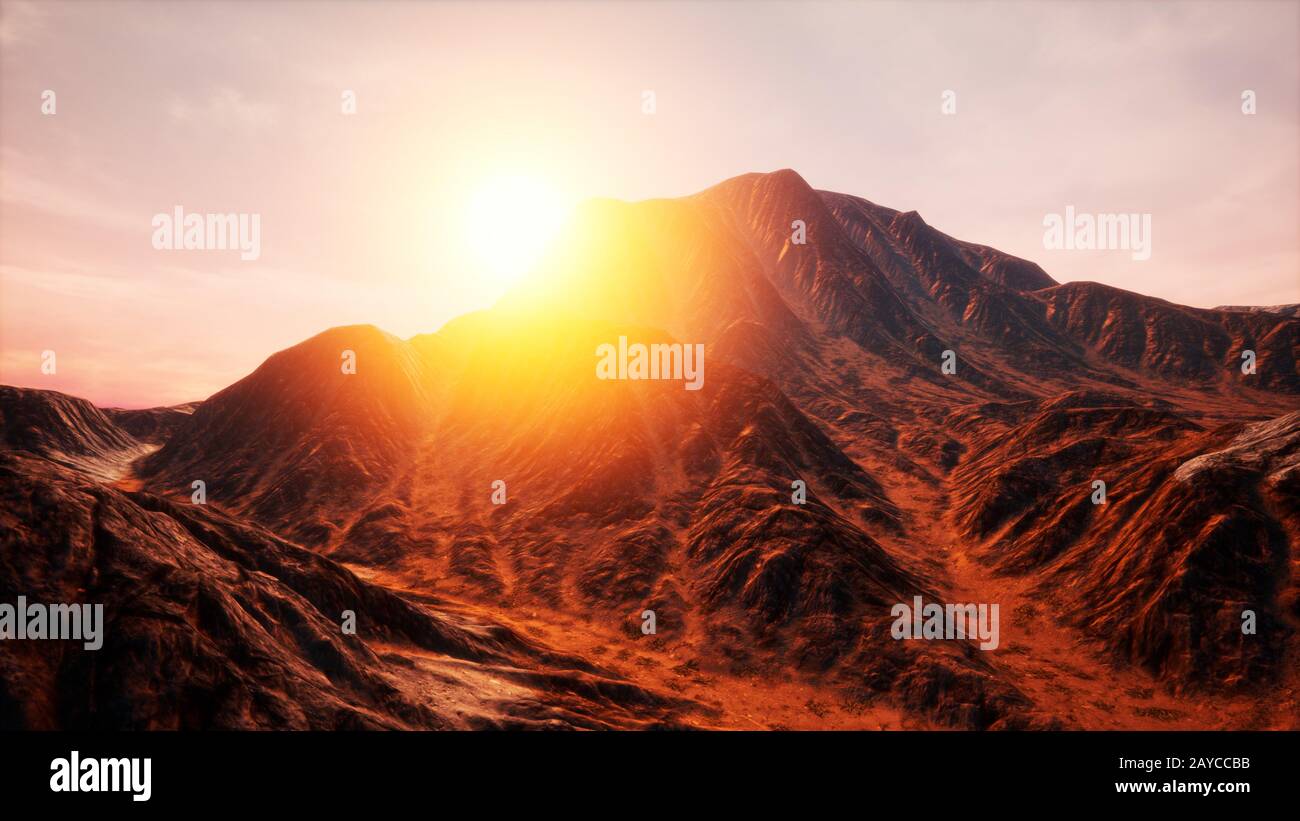 Sun Rays over Mountains in a Valley Stock Photo - Alamy