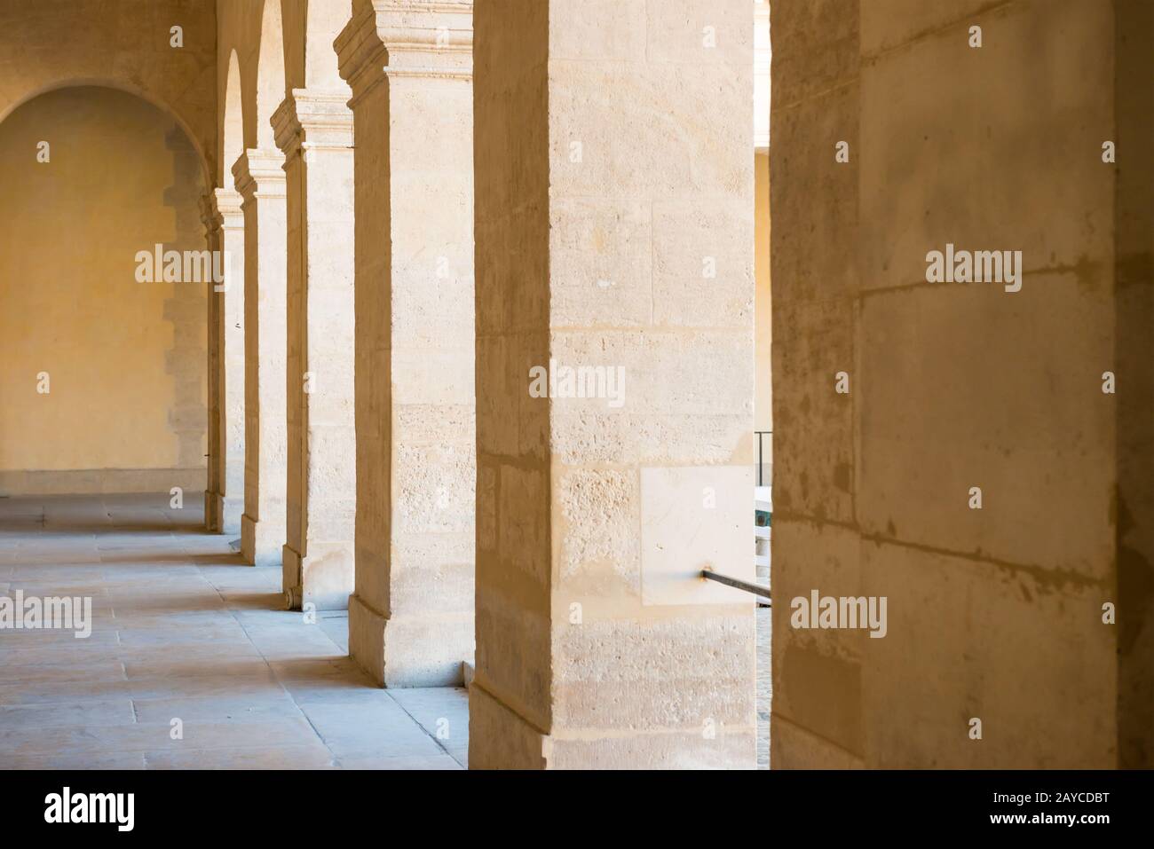 Corridor with arch and stone columns Stock Photo - Alamy