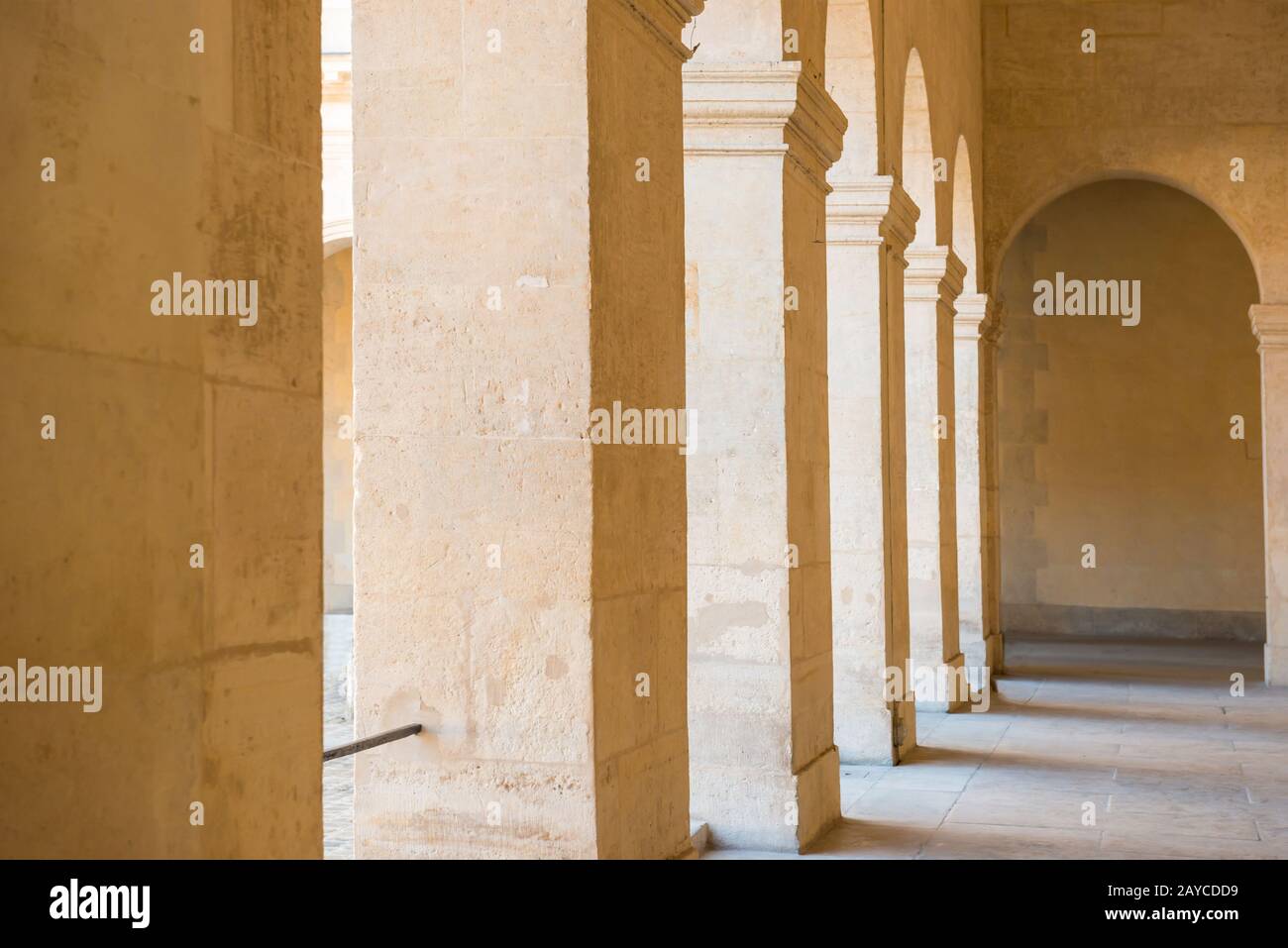 Corridor with arch and stone columns Stock Photo - Alamy