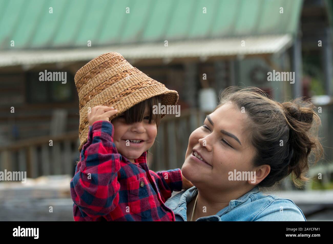 Portrait of a Tlingit mother with her small boy wearing a traditional ...