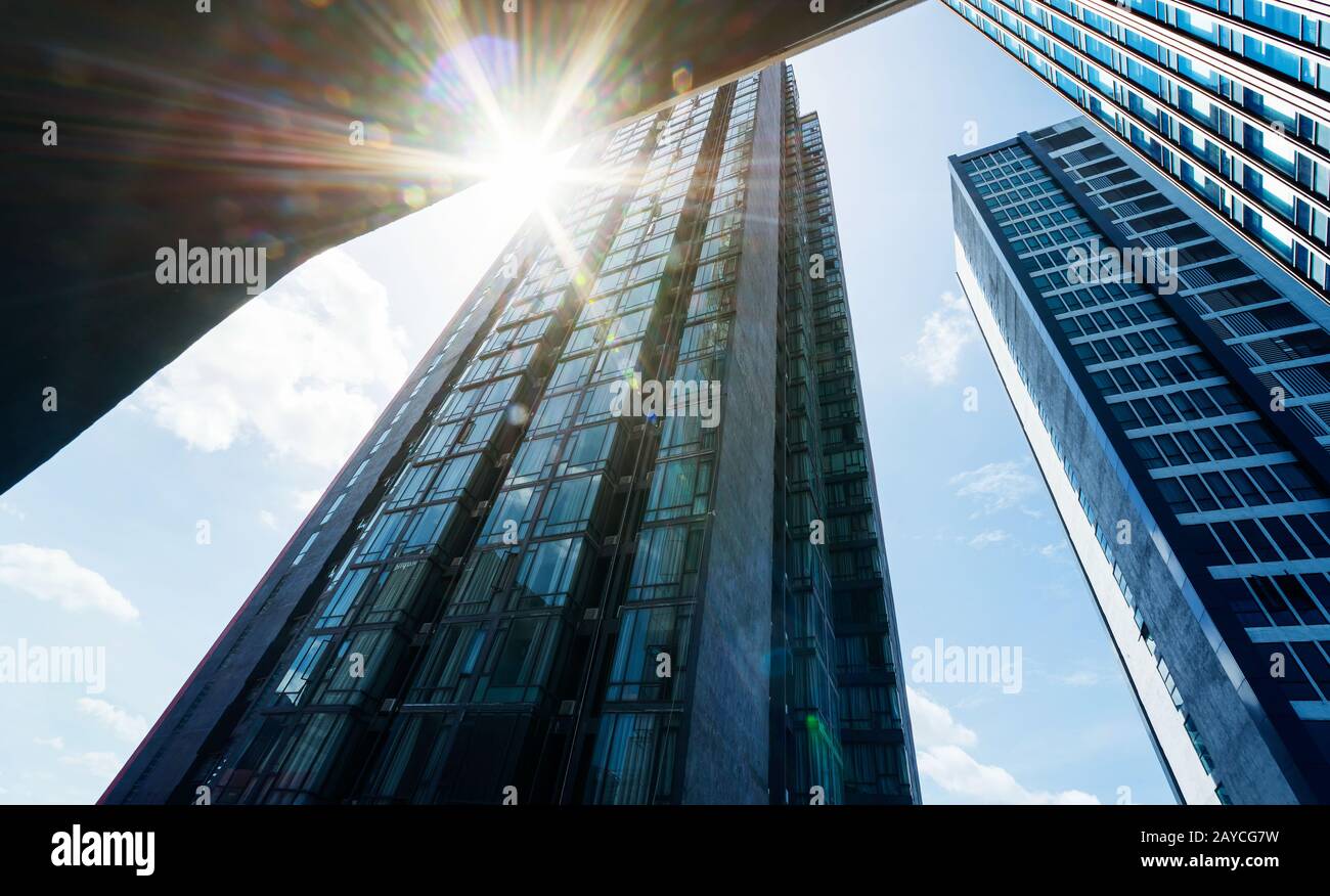 Low angle view of common modern business skyscrapers with sun flare ...