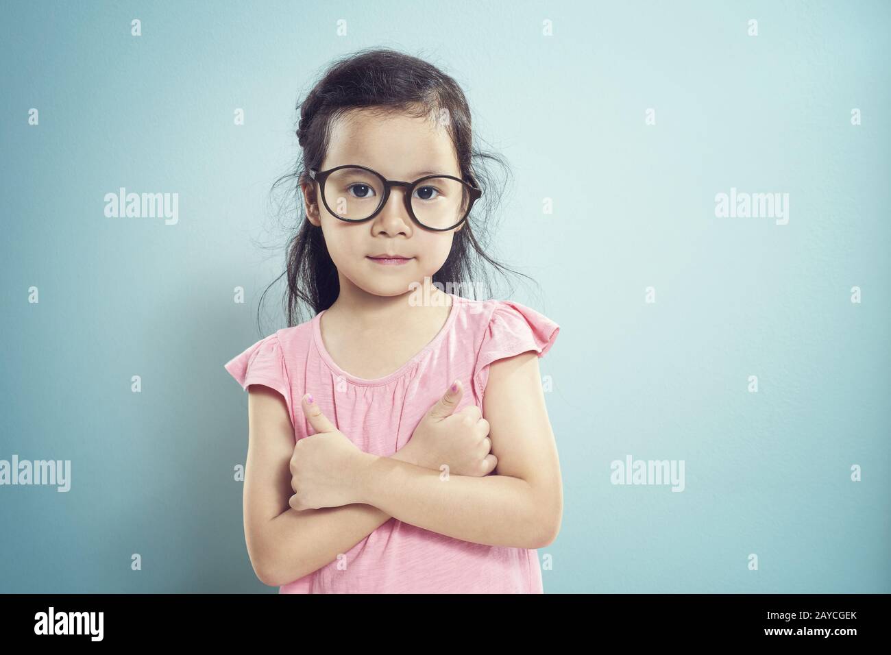Portrait of young asian little cute girl shows a thumbs up by two ...