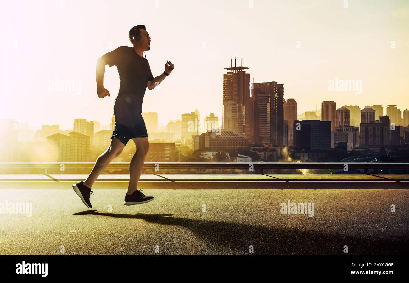 The runner on the urban street be running for exercise Stock Photo - Alamy