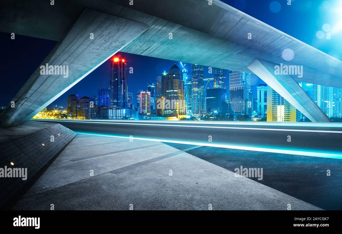 Empty asphalt road under the bridge during the night with beautiful ...