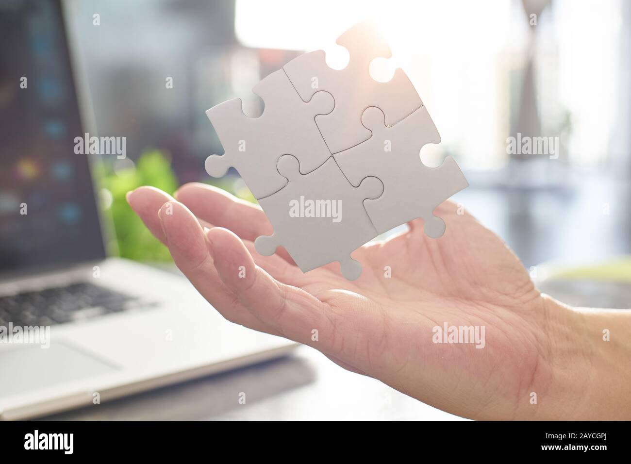 Young businessman showing puzzle partnership puzzle piece with sun ...