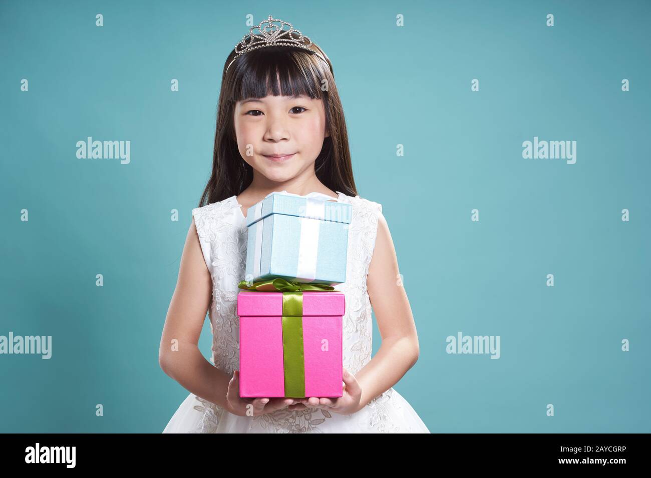 Portrait of little asian beautiful girl holding two present box on ...