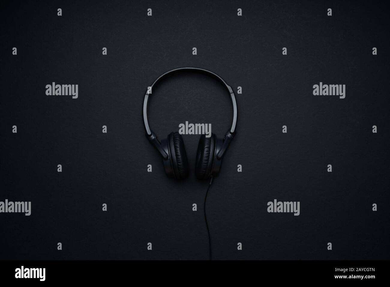 Black earphone isolated on black background . Flat lay and top view ...
