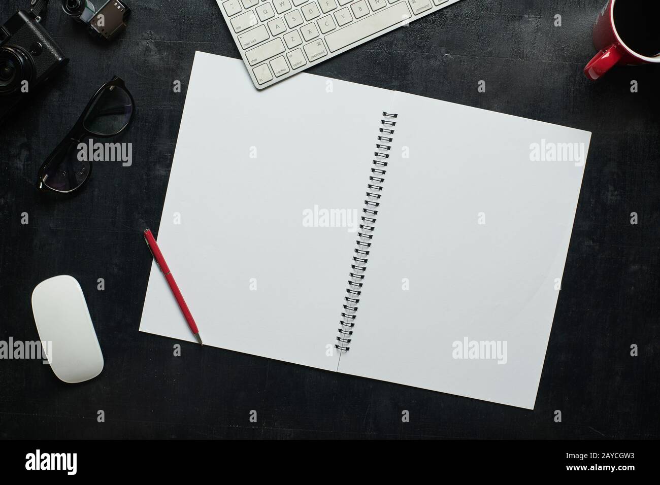 Wooden black office desk table with notebook Stock Photo - Alamy