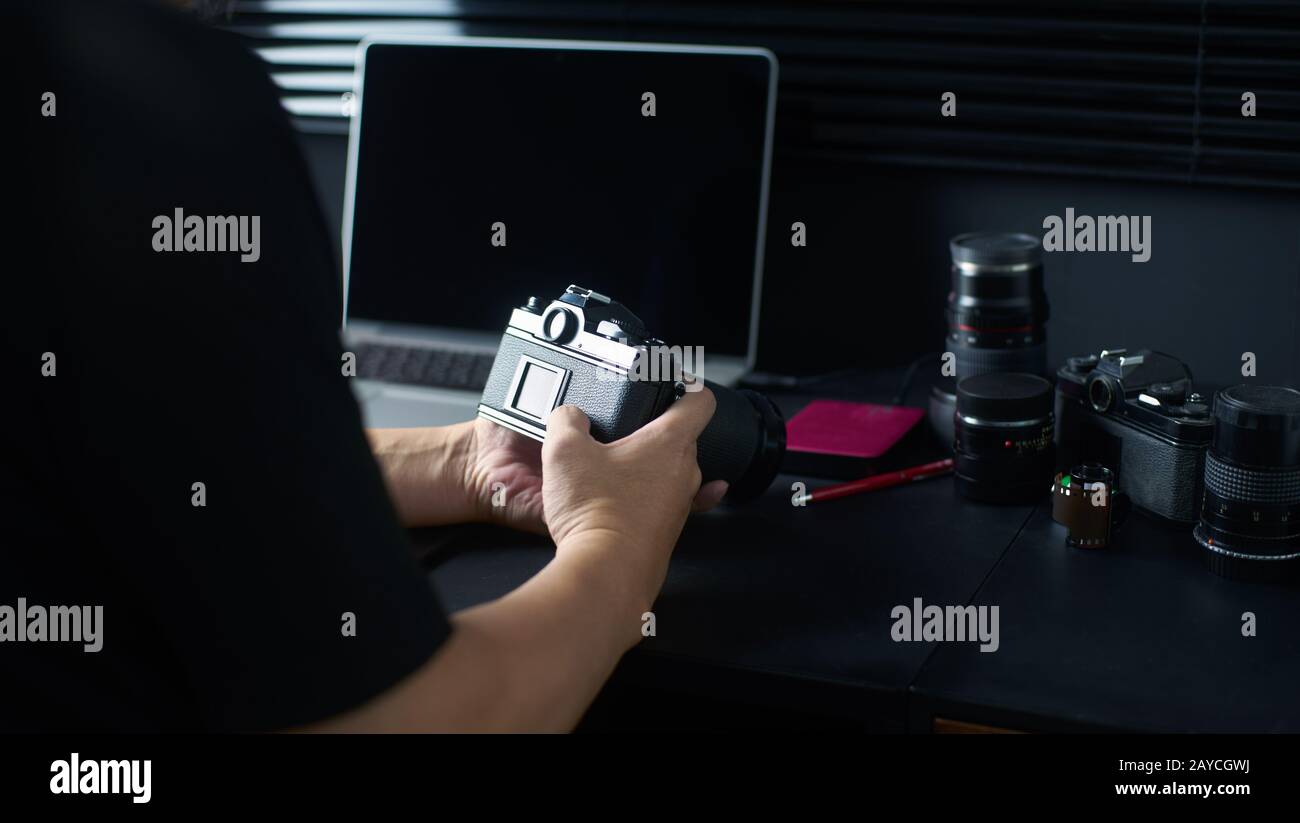 Photographer working checking camera Stock Photo - Alamy