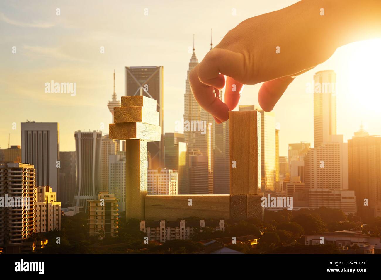 Unknown hand build a wooden blocks tower in downtown . Learning Stock ...