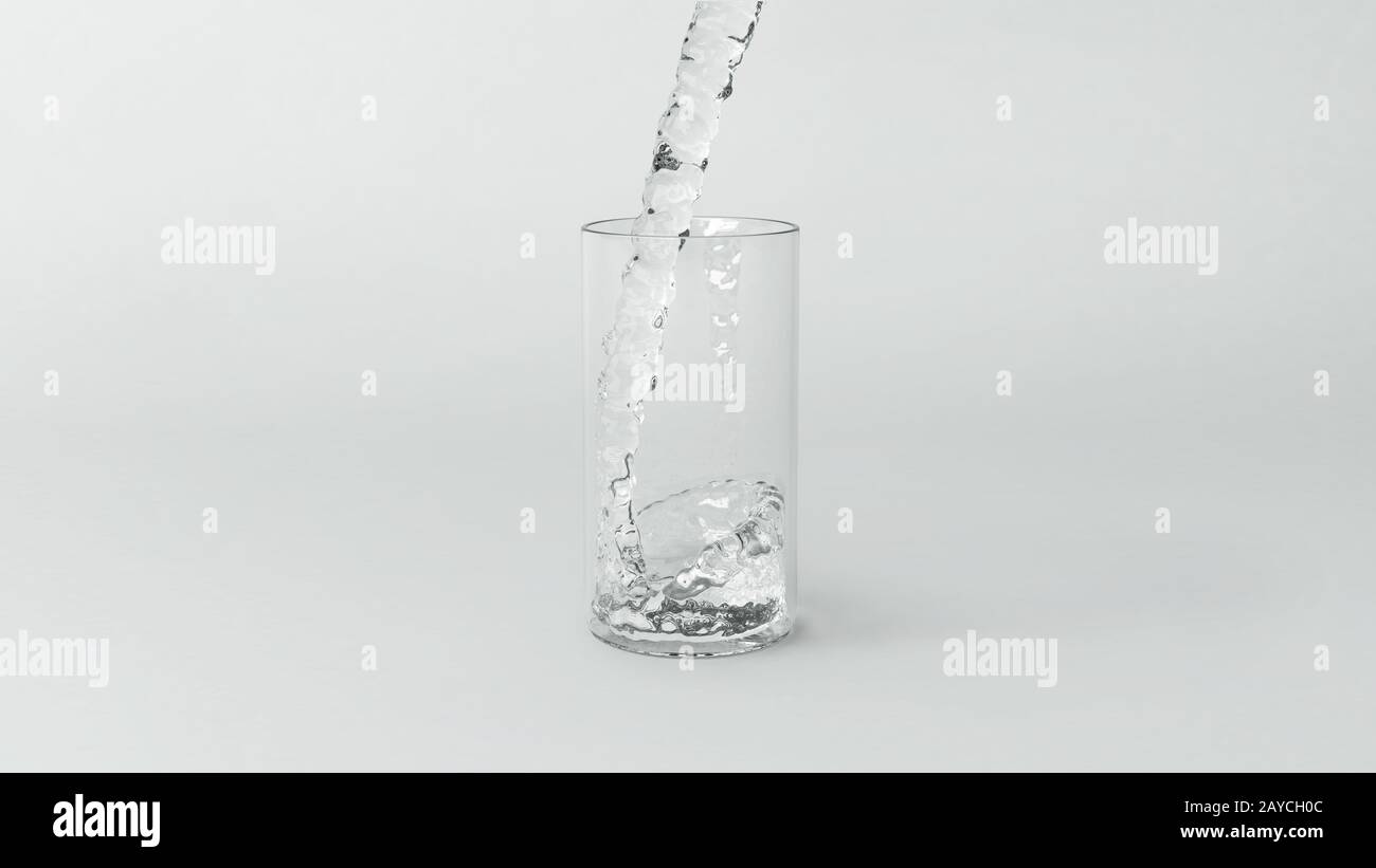 Pour water into the glass isolated on white background Stock Photo - Alamy