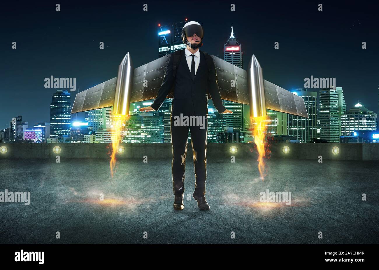 Businessman wear a rocket suit to lift Stock Photo - Alamy