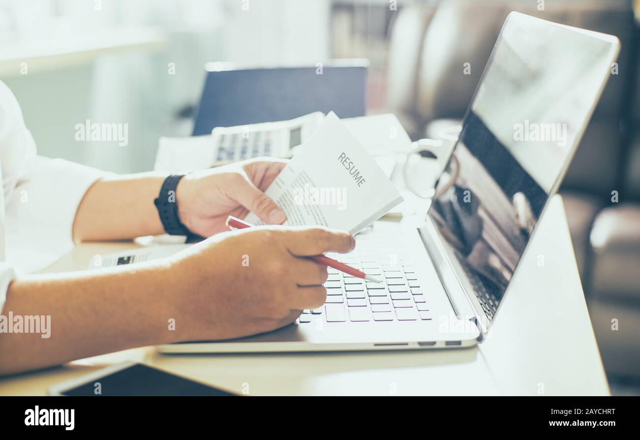Business man review his resume on his desk Stock Photo - Alamy