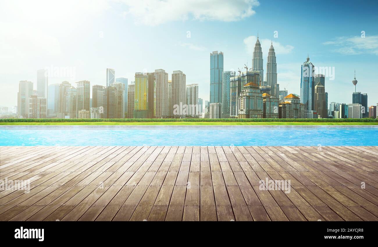 Wooden perspective brown empty floor in front of swimming pool with ...