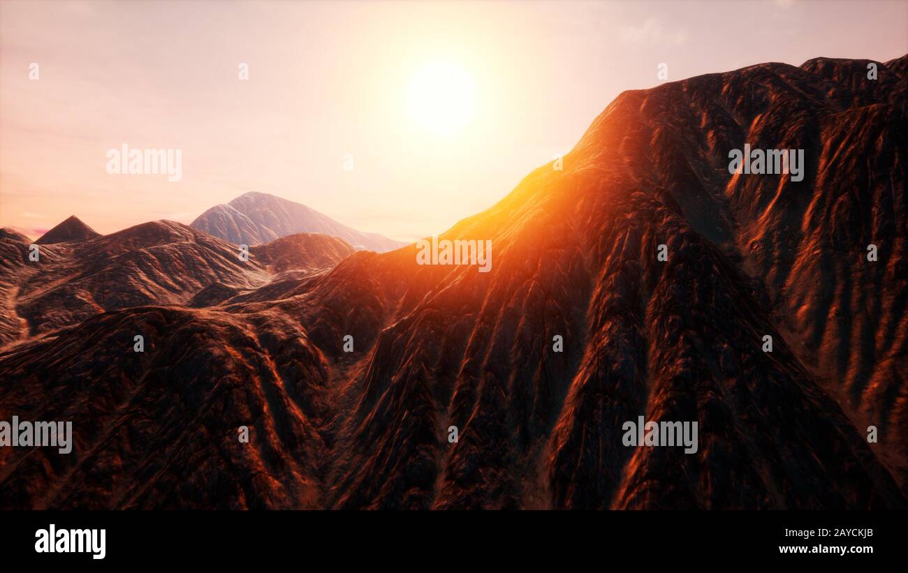 Sun Rays over Mountains in a Valley Stock Photo - Alamy