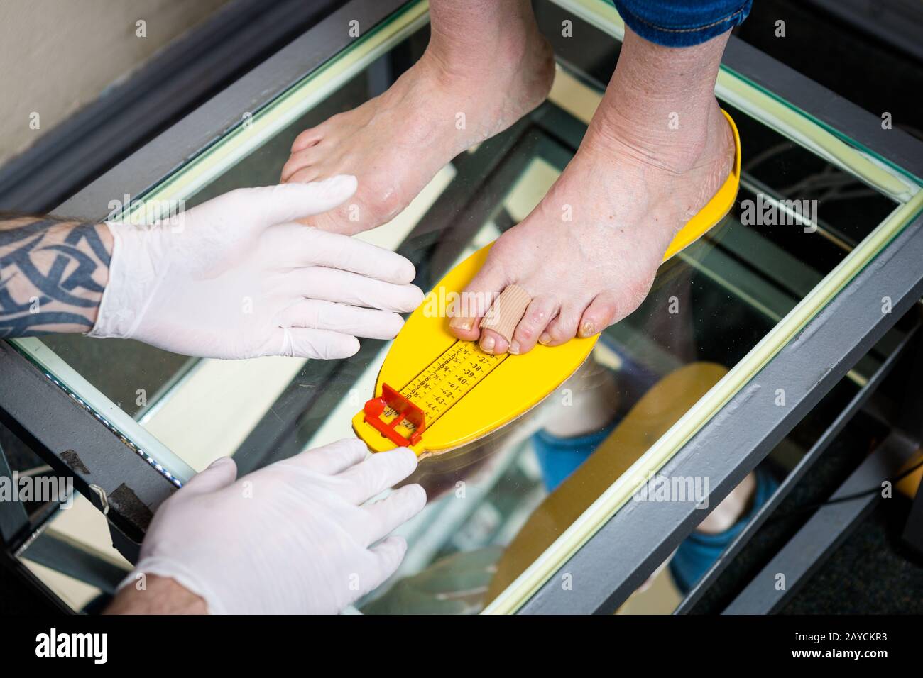 Orthopedics and medicine. Young Caucasian doctor hands man tattoo latex ...