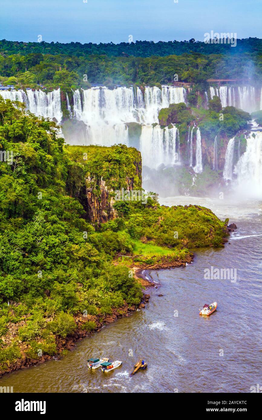 Small boats transport curious tourists to waterfalls Stock Photo - Alamy