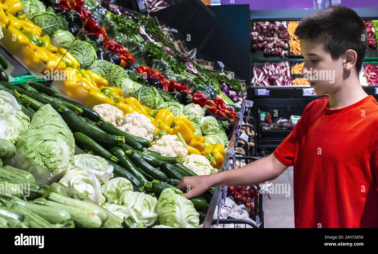 Child selecting vegetables on shelf in supermarket Stock Photo - Alamy
