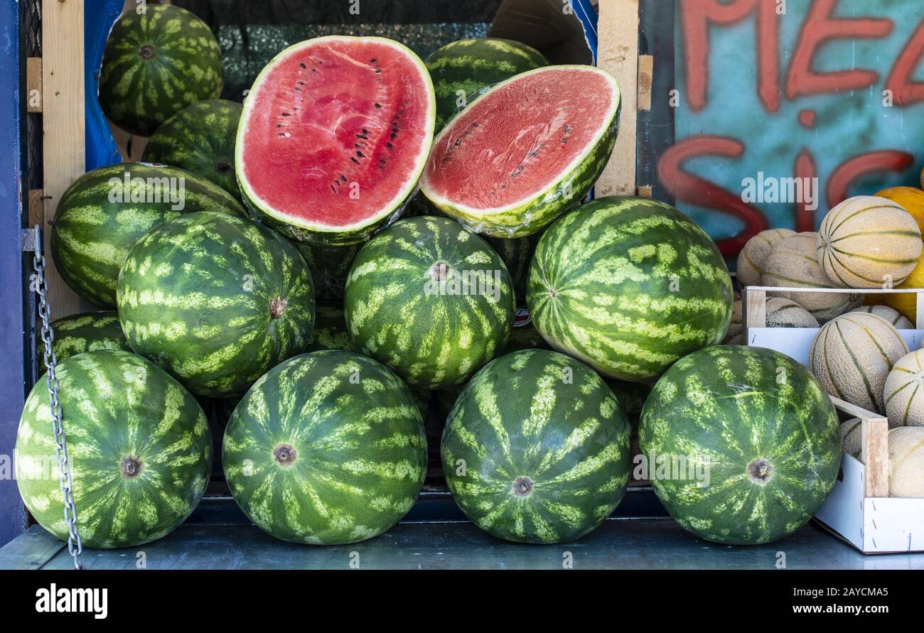 Watermelons on shelf. Cutted watermelon on street market Stock Photo ...