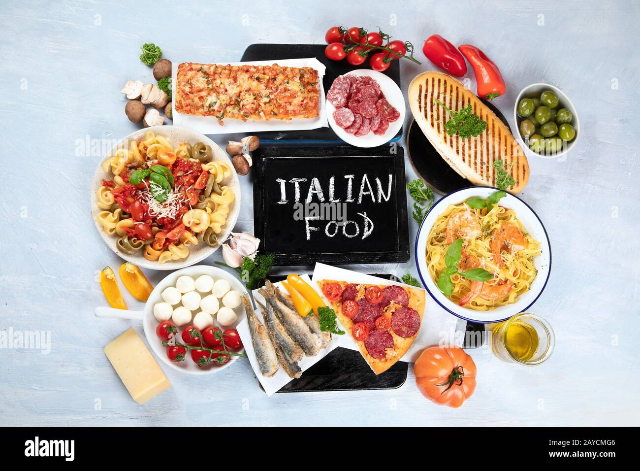 Traditional Italian foods with pizza, pasta, olives, vegetables ...